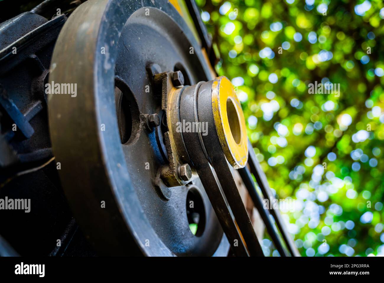 Driven pulley of a walk-behind tractor with two belts close-up on a ...