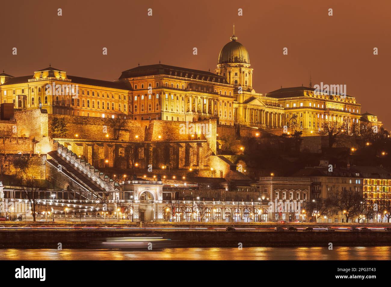 Budapest, Hungary Illuminated night view of Buda Castle Palatial venue, seen from the banks of ...