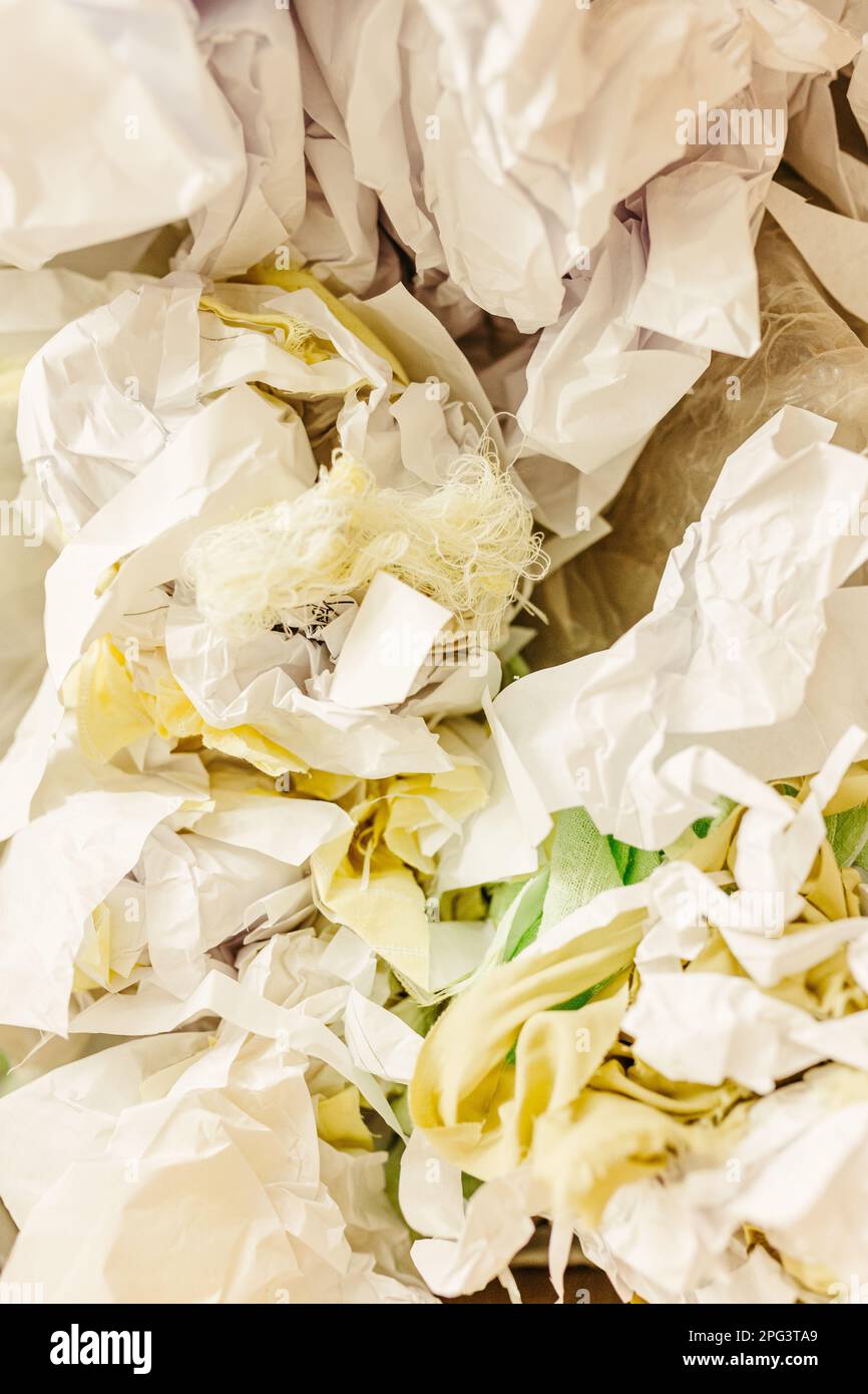 A closeup of white and yellow crumpled papers and swatches background ...