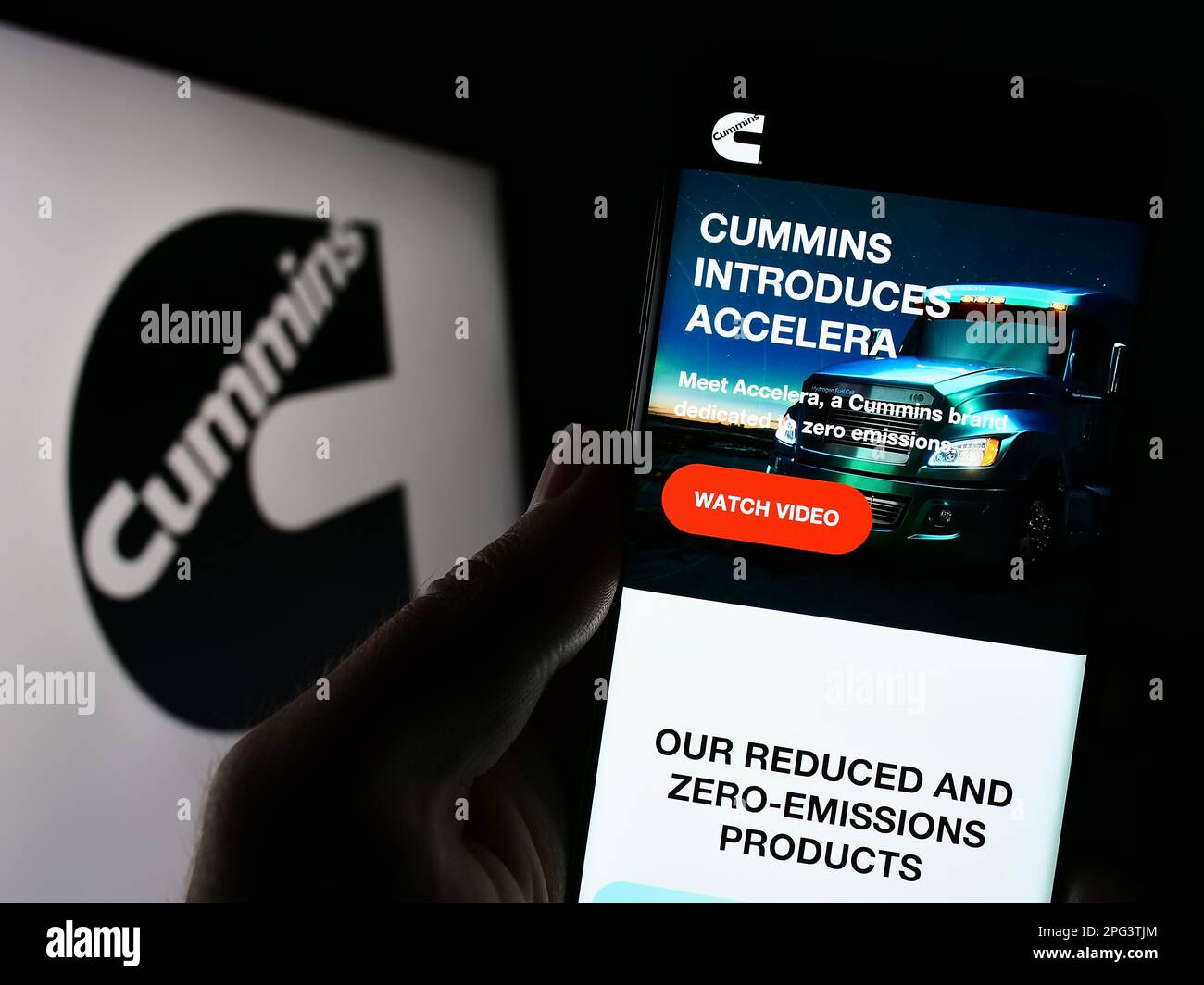 Person holding smartphone with webpage of US manufacturing company ...