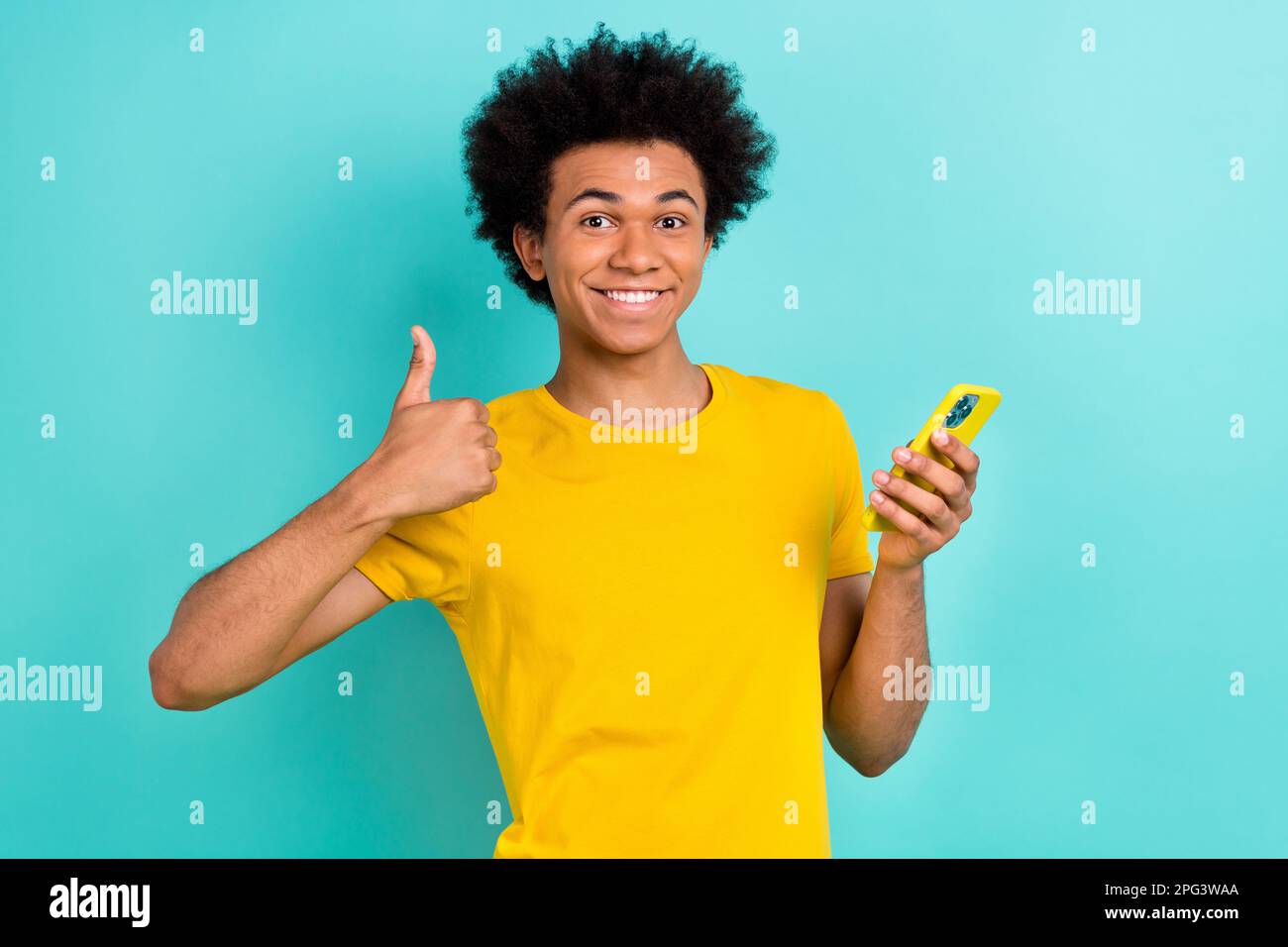 Photo of satisfied handsome guy afro hairstyle dressed yellow t-shirt ...