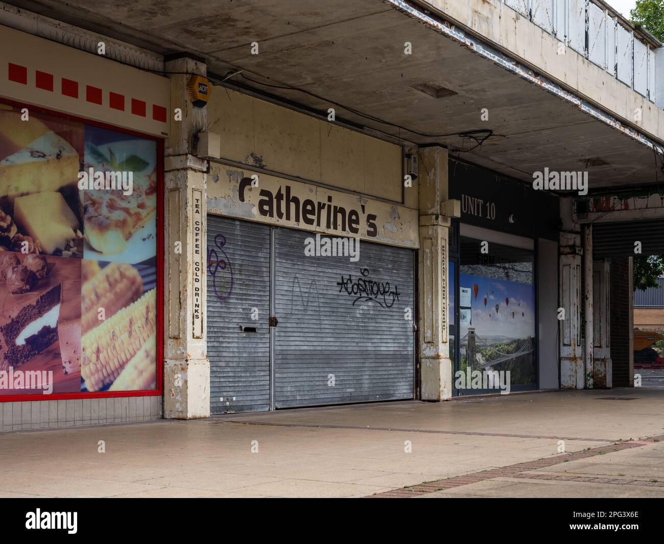Shop units stand empty and shuttered in a derelict shopping precinct in ...