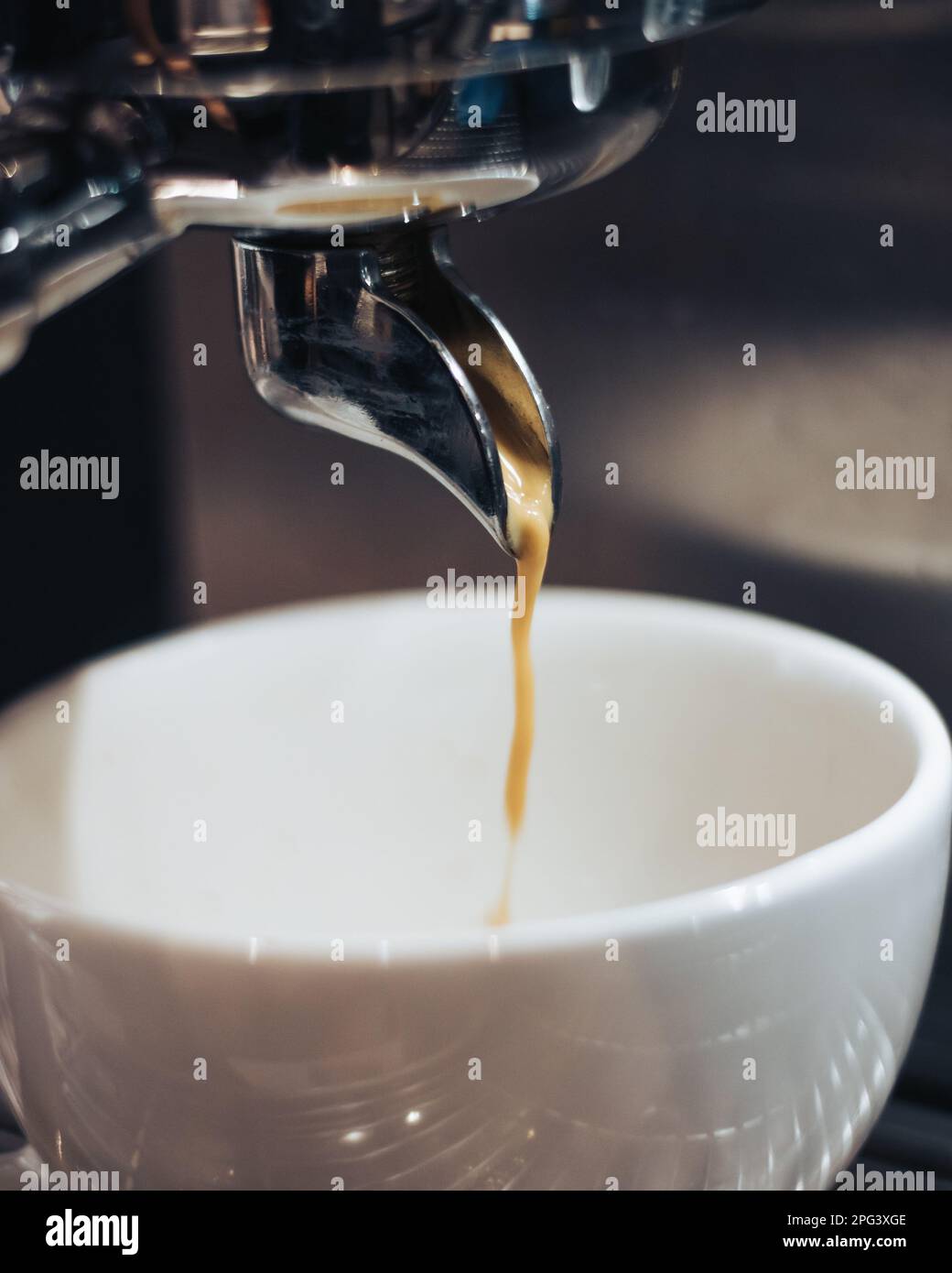 Brewing coffee, espresso machine pouring hot liquid into a cup ...