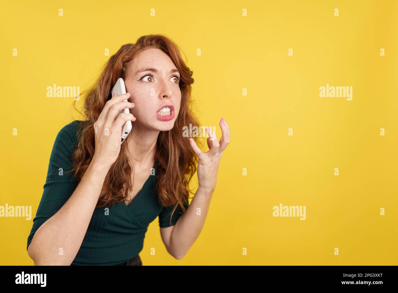 Angry redheaded woman talking mobile hi-res stock photography and ...