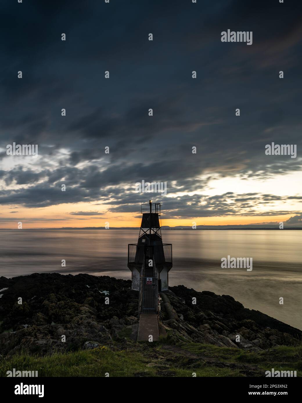 The sun sets over Battery Point Lighthouse at Portishead on the Bristol ...