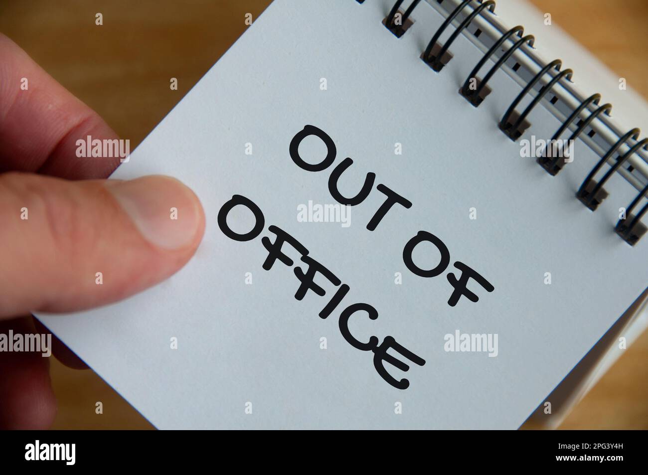 Top view of Out Of Office notification text on white notepad. Business ...
