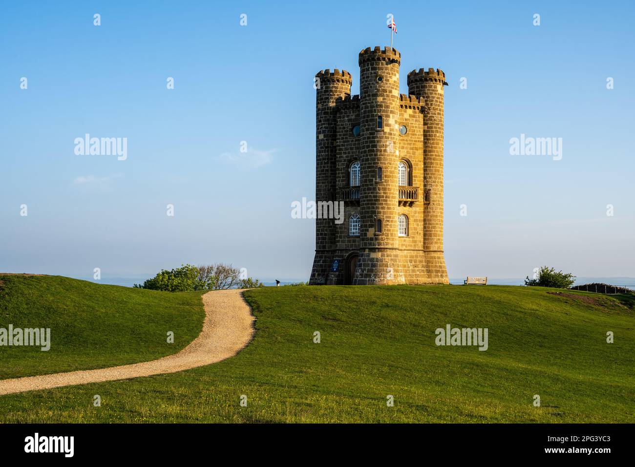 Morning sun shines on Broadway Tower folly in England's Cotswolds Hills ...