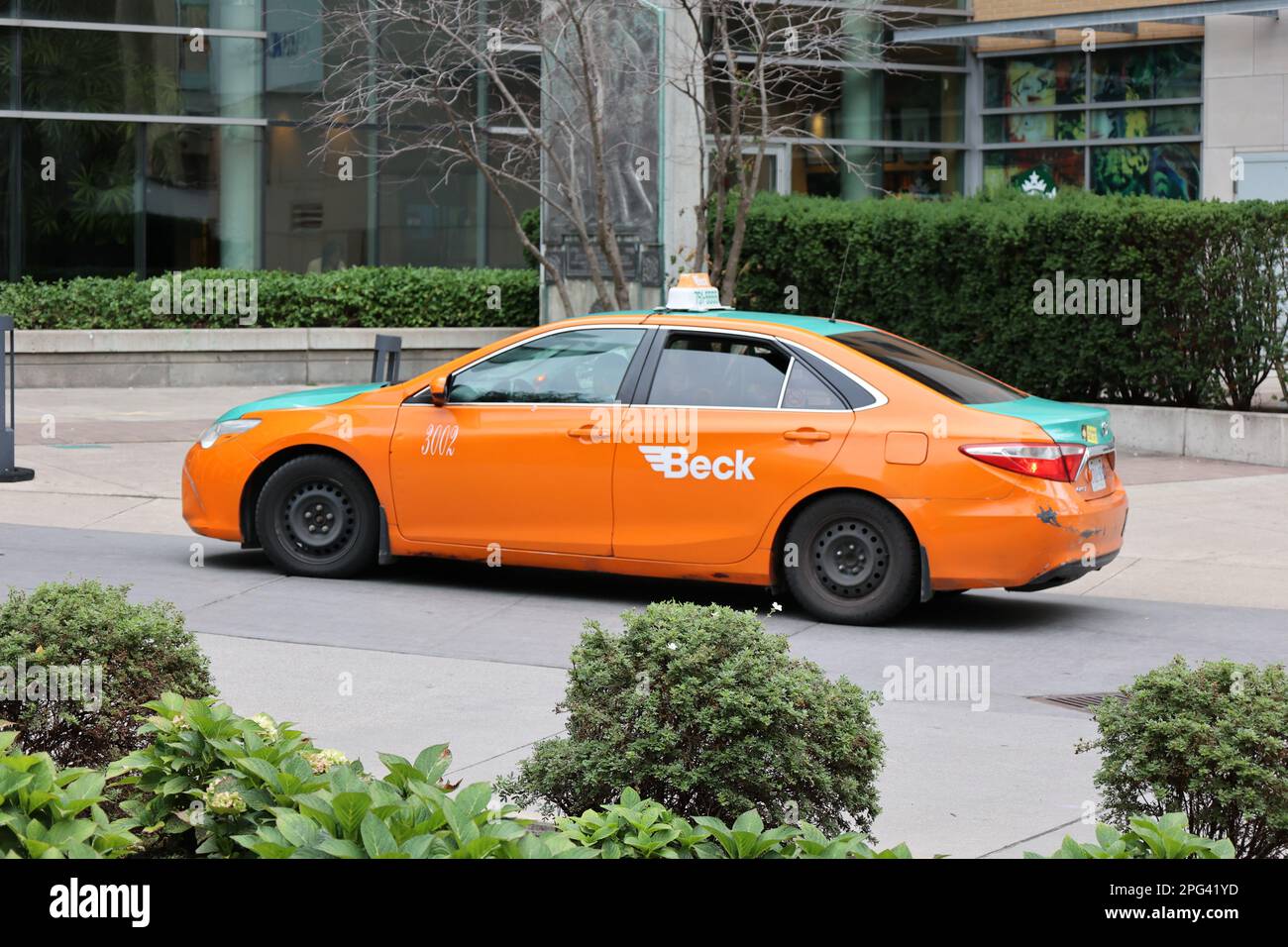 Orange Beck Taxi Cab is parked outside a building Stock Photo - Alamy