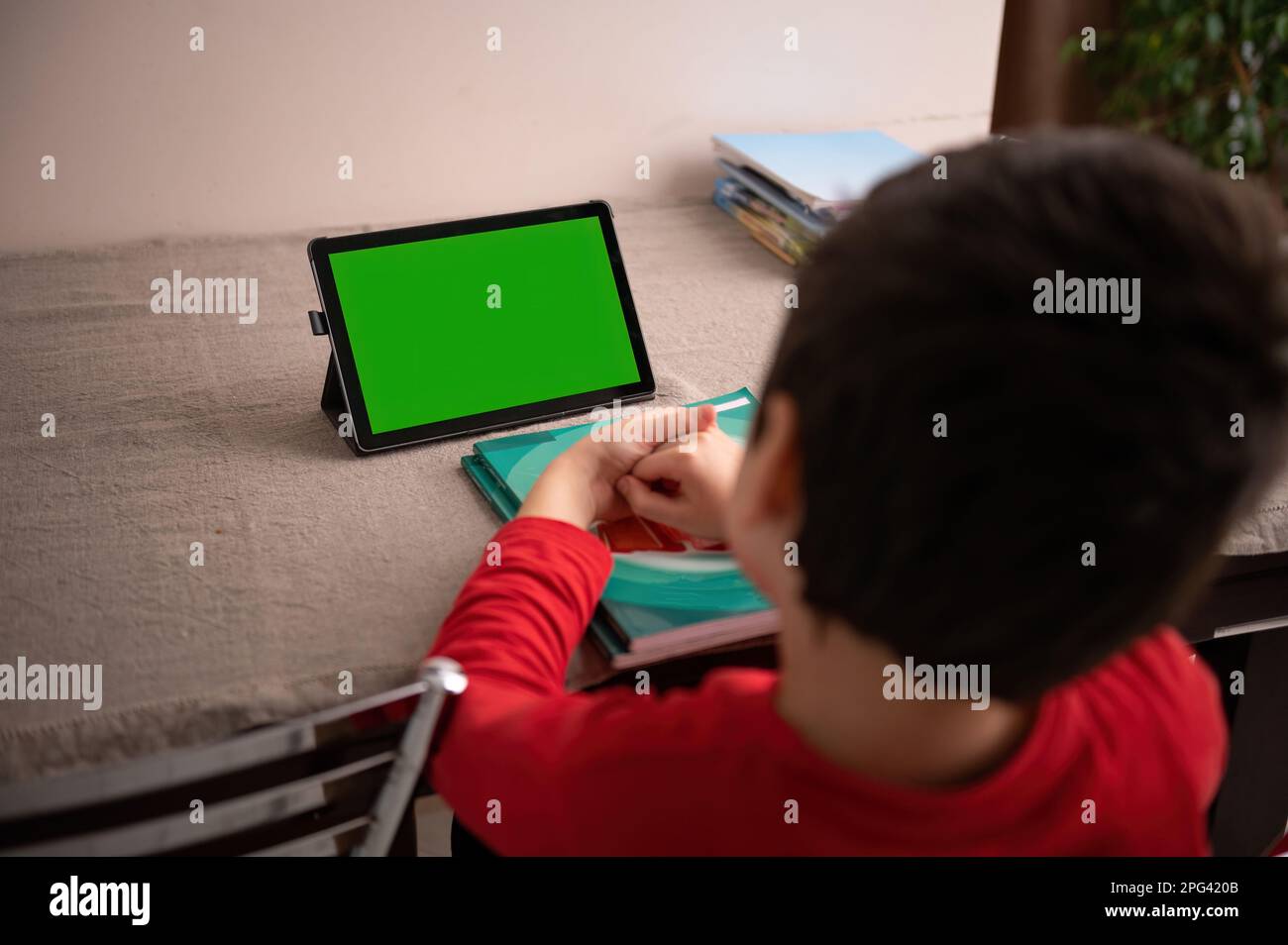 Smart student sitting a table a watching online lesson on a digital ...