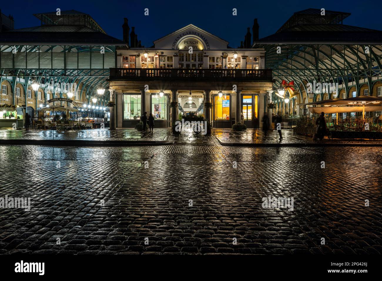The regenerated covered market hall at Covent Garden is lit at night in ...