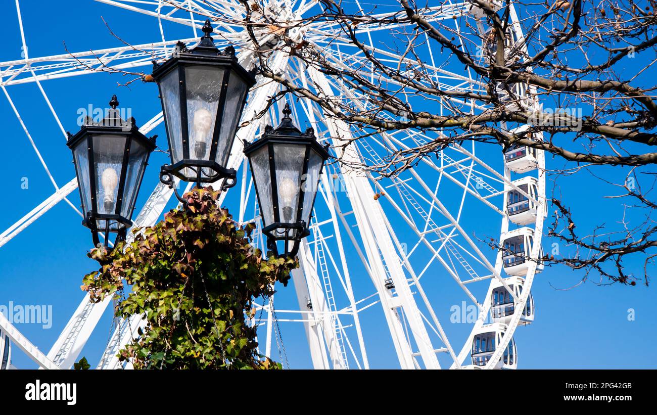 Closeup street lamp with white ferries wheel in bg, ideal for ...