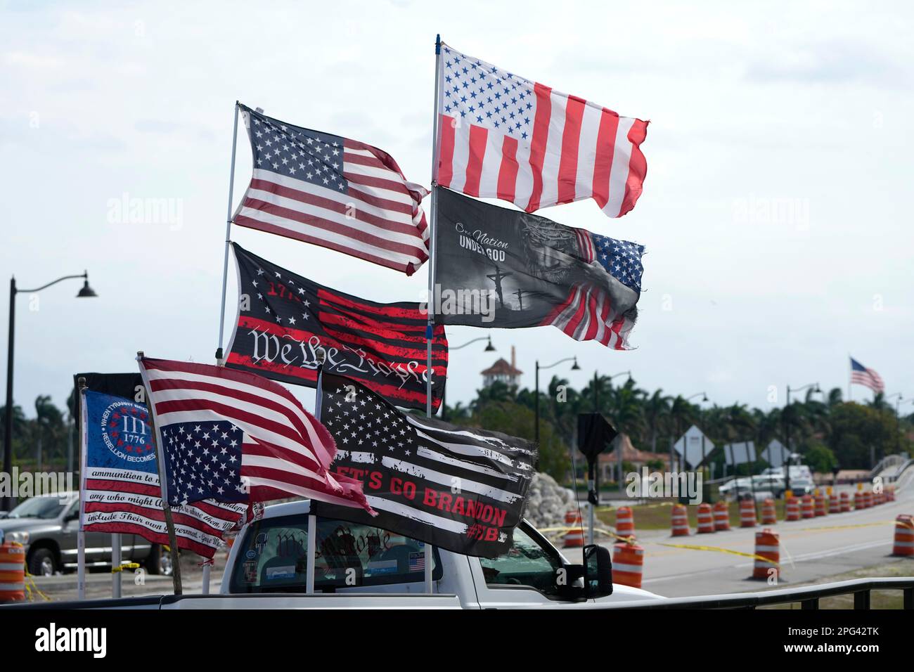 Flags fly from a former President Donald Trump supporter's truck ...