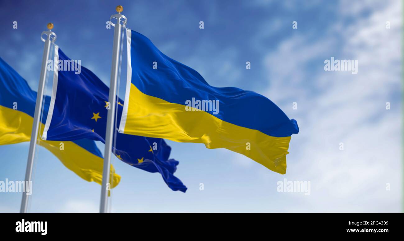 flags of Ukraine waving with European Union flag on a clear day ...