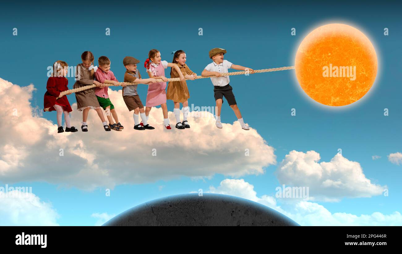 Happy playful little kids, boys and girls playing together, pulling sun ...