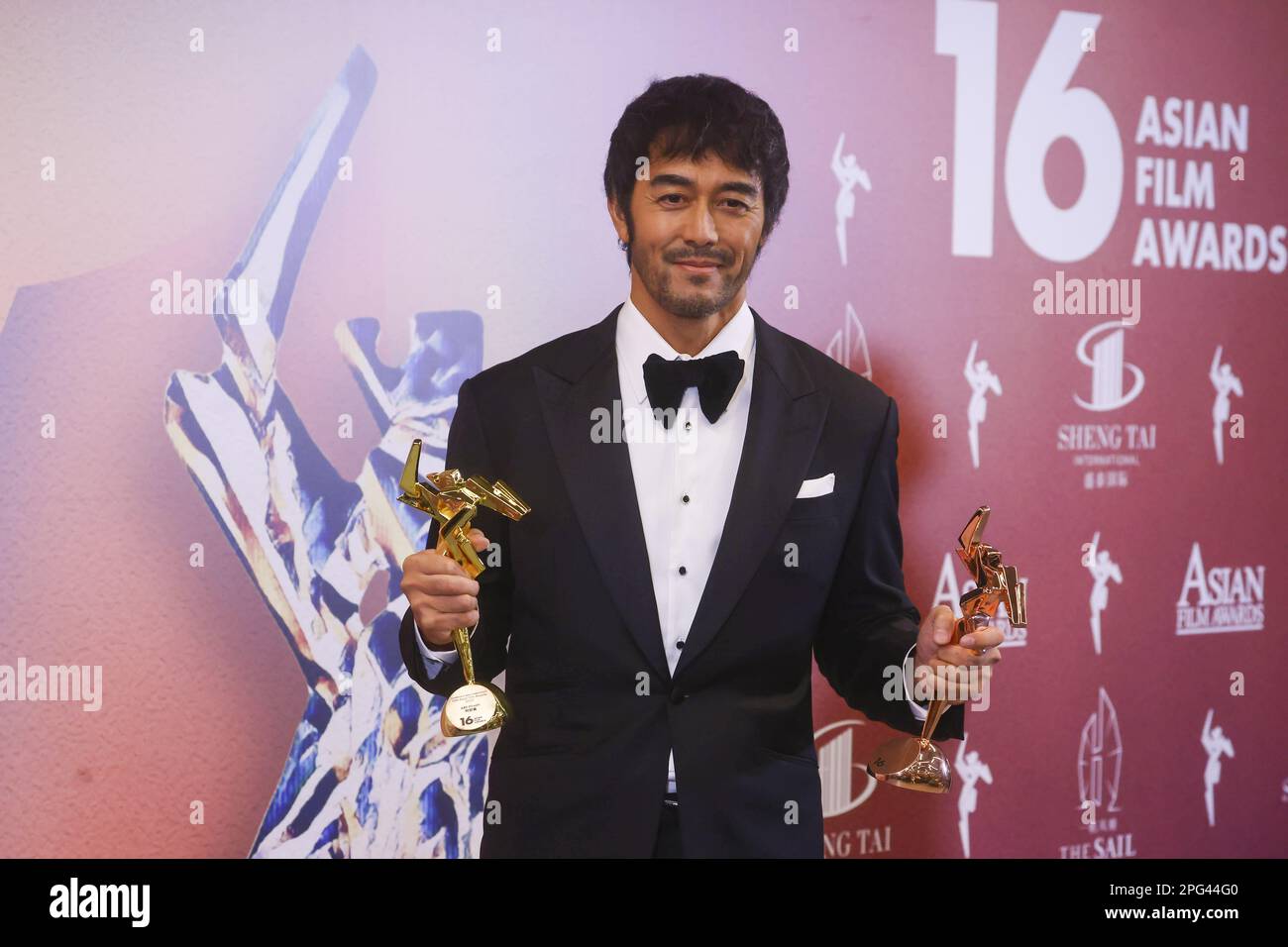 Japanese actor Hiroshi Abe holds his trophy after winning the ...