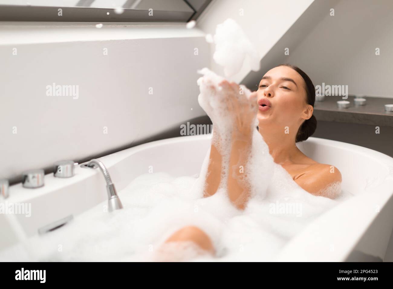 Lady Taking Bath Having Fun Blowing Foam Bubbles In Bathroom Stock ...