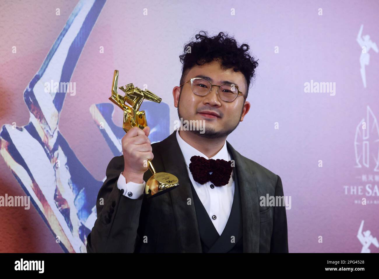 Mak Pui-tung, poses with the trophy after winning the best newcomer for ...