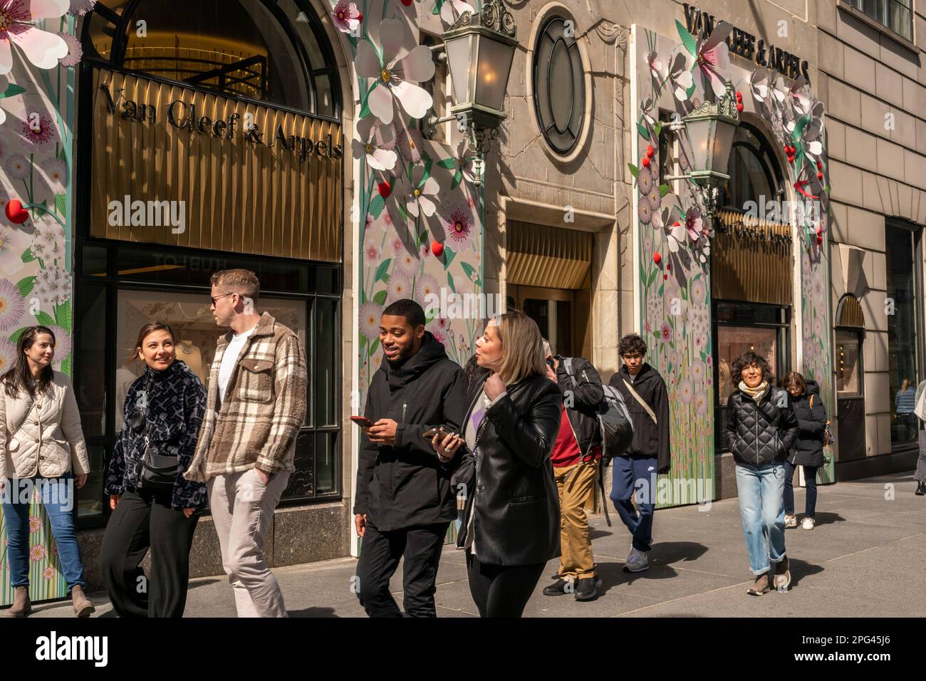 People walk past the Van Cleef & Arpels jewelers, decorated for Spring ...