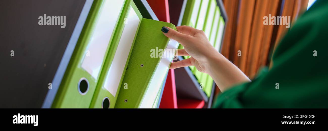 Secretary takes out business folder with documents from cabinet Stock ...