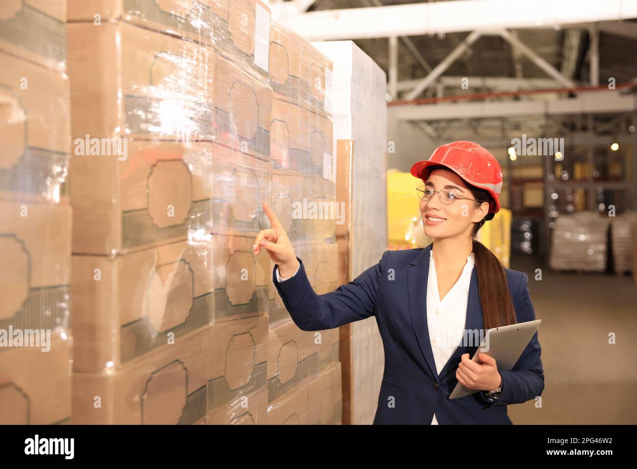 Manager with tablet working at warehouse. Logistics center Stock Photo ...