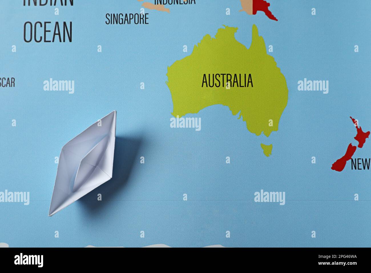 White paper boat on world map, top view Stock Photo - Alamy