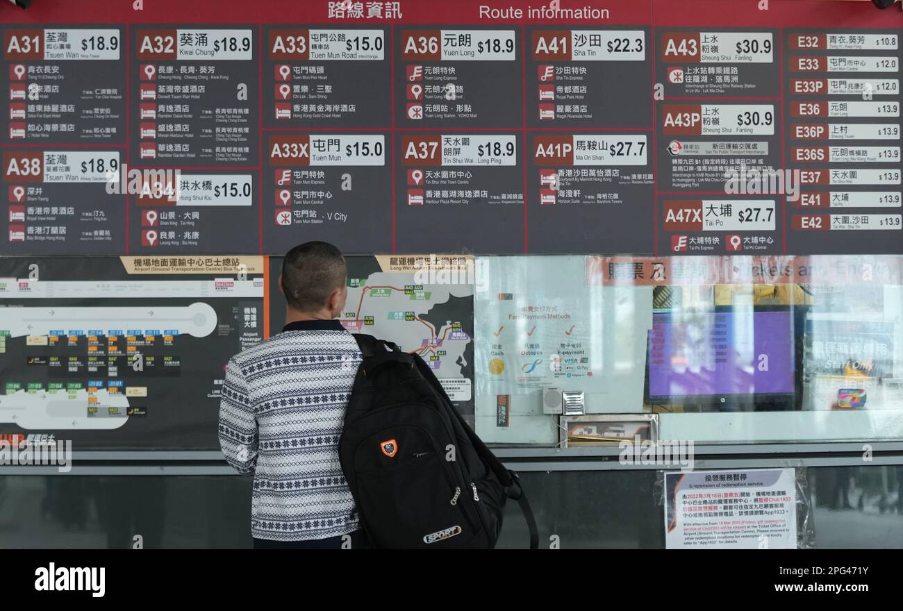A man stands in front the ticket counter of Long Win Bus at the bus ...