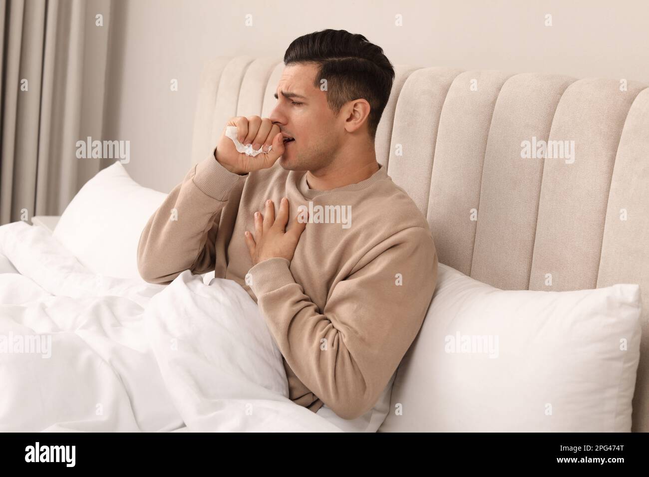 Sick man with tissue suffering from cold in bed at home Stock Photo - Alamy