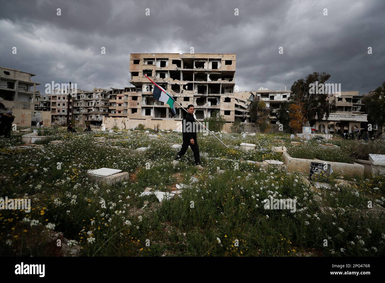A man carries Palestinian flag during the funeral of Ali Ramzi al-Aswad ...