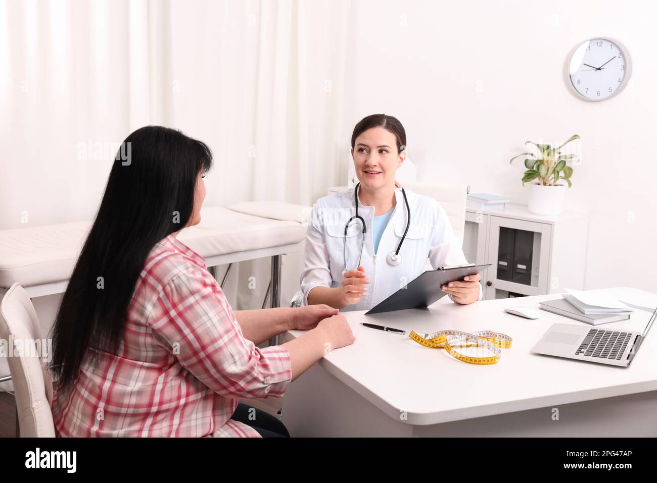 Female doctor consulting overweight patient hi-res stock photography ...