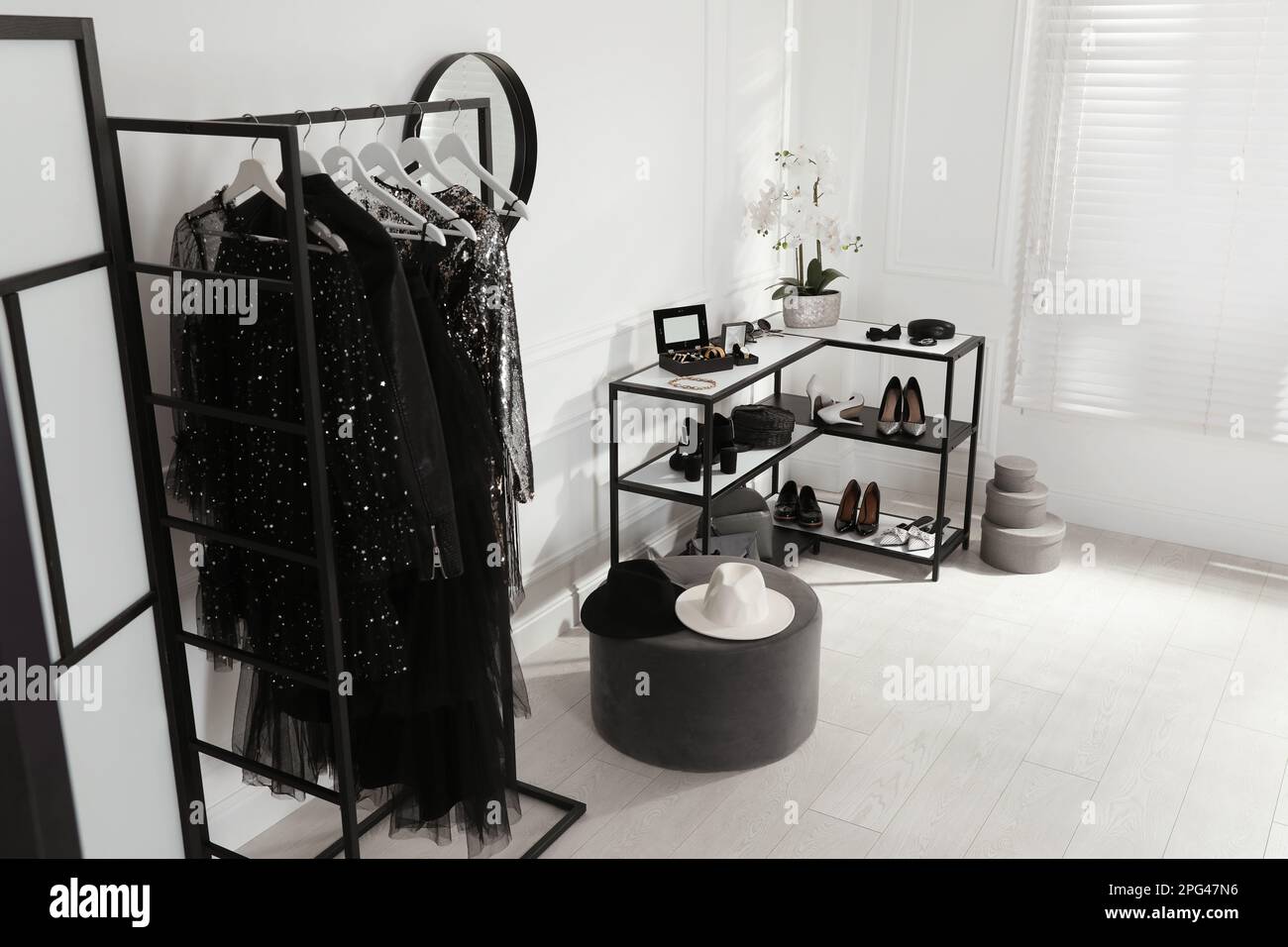 Stylish dressing room interior with trendy clothes, shoes and ...