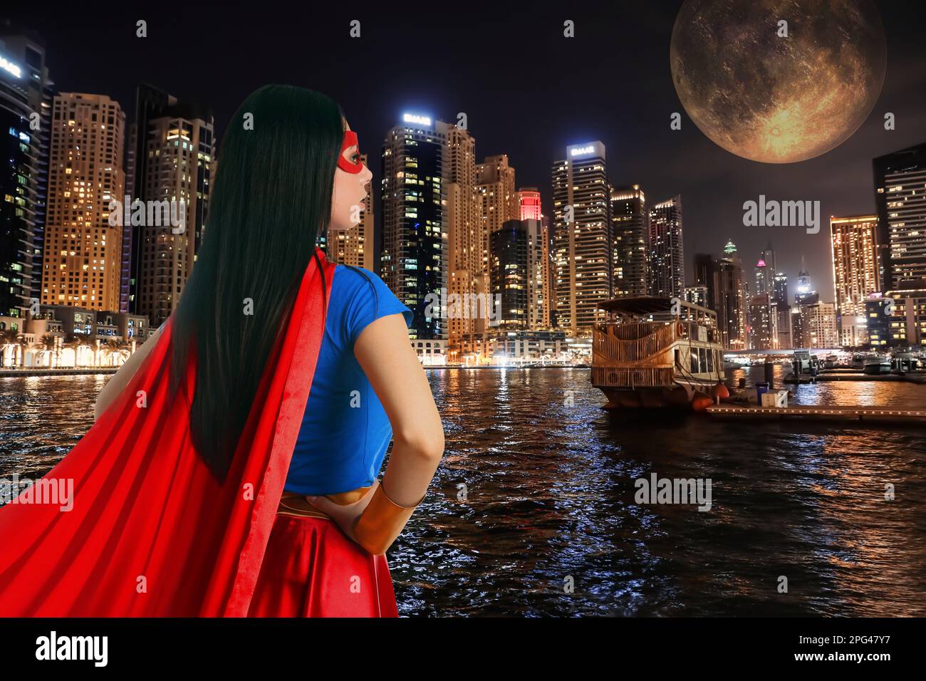 Confident young woman wearing superhero costume and beautiful cityscape ...