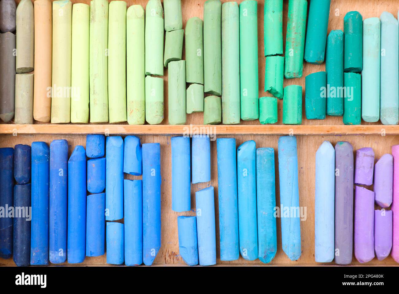 Set of soft pastels in wooden box as background, top view. Drawing ...