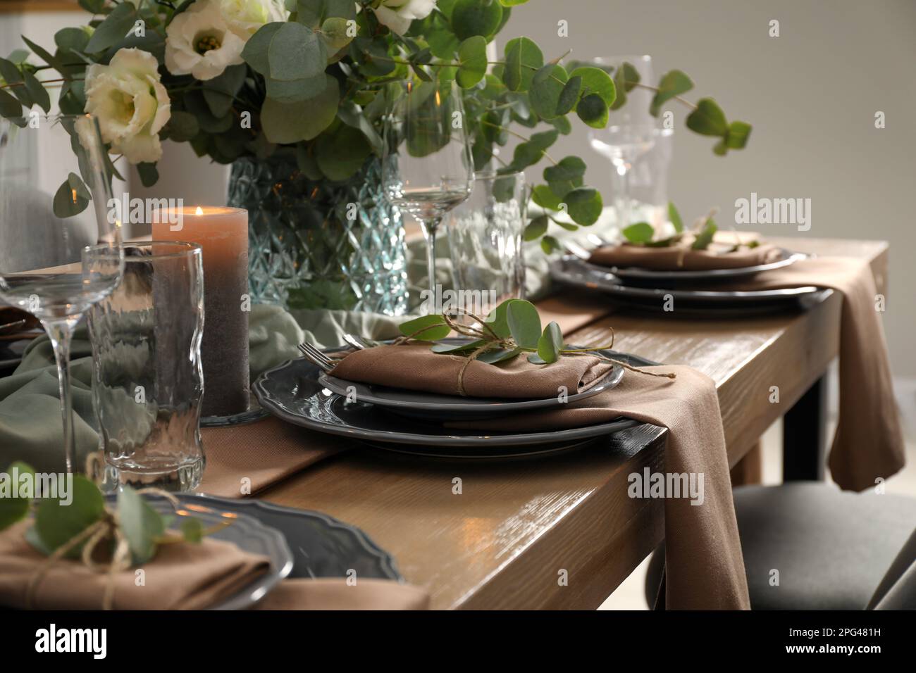 Festive table setting with beautiful floral decor indoors Stock Photo ...
