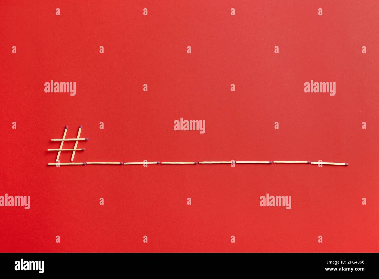 Hashtag symbol and space for text made of wooden matches on red ...