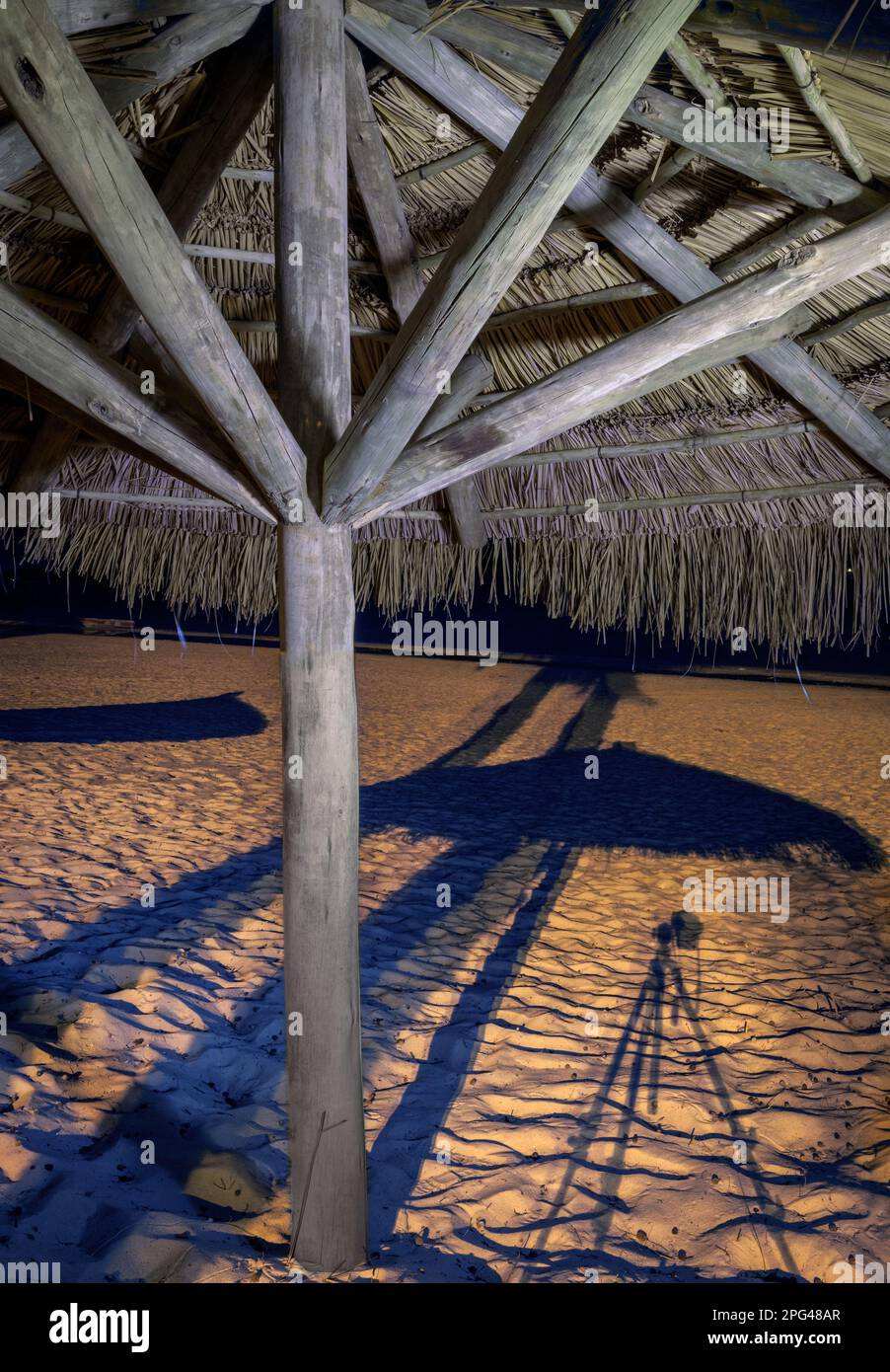 Permanent grass sun-shades stand on a the beach at Makuzi beach along ...