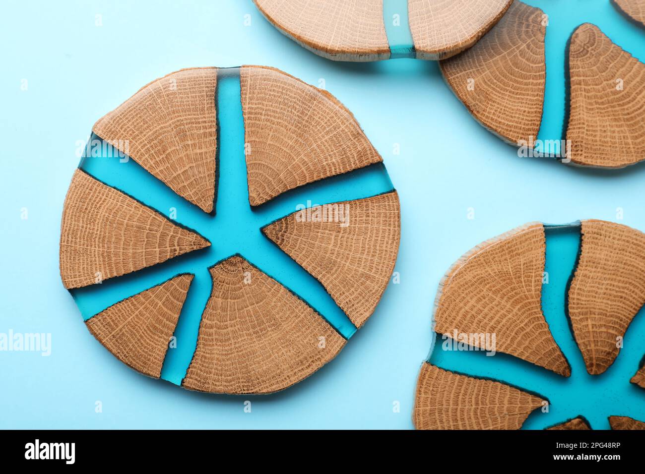 Stylish wooden cup coasters on light blue background, flat lay Stock ...