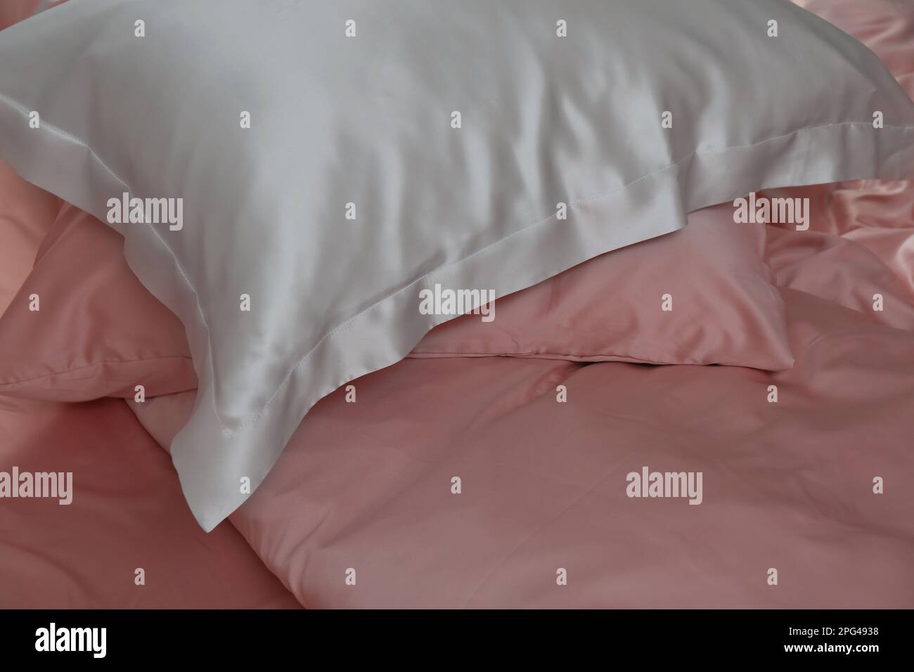 Closeup view of bed with beautiful silk linens Stock Photo - Alamy