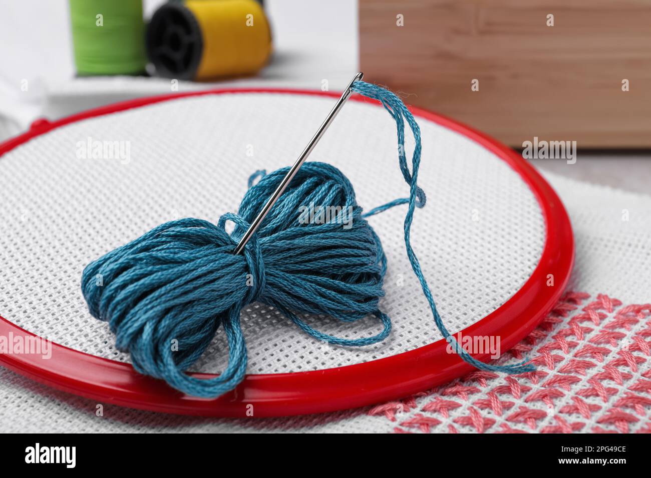 Embroidery hoop with fabric and needle on table, closeup Stock Photo ...