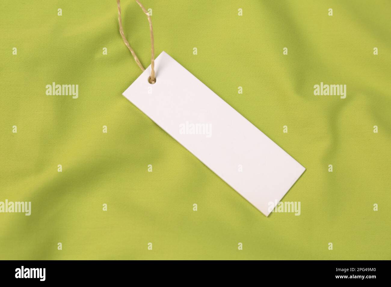 Blank white tag on green fabric, top view. Space for text Stock Photo ...