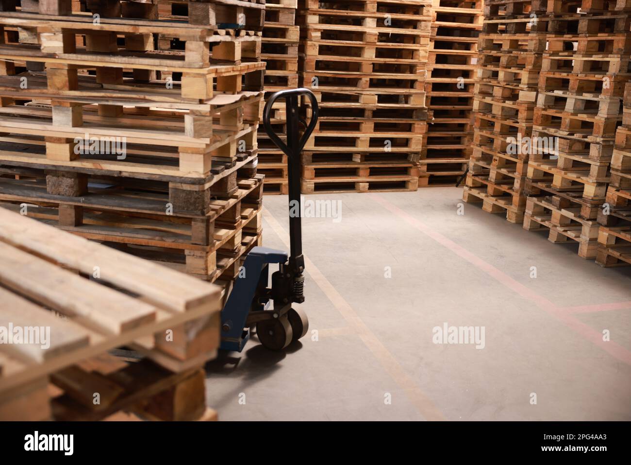 Modern manual forklift with wooden pallets in warehouse, space for text ...