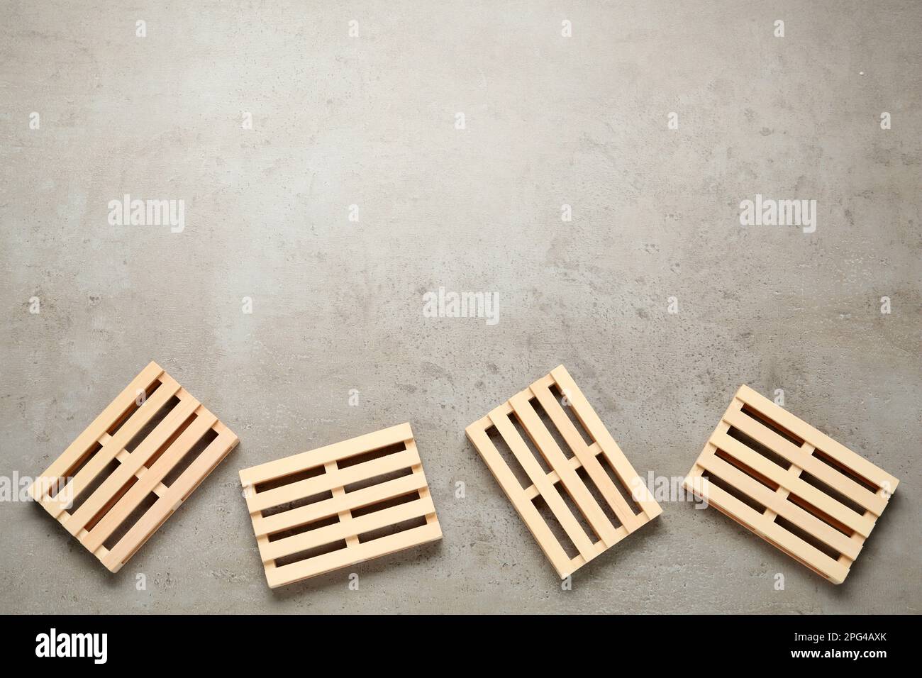 Wooden pallets on light grey table, flat lay. Space for text Stock ...