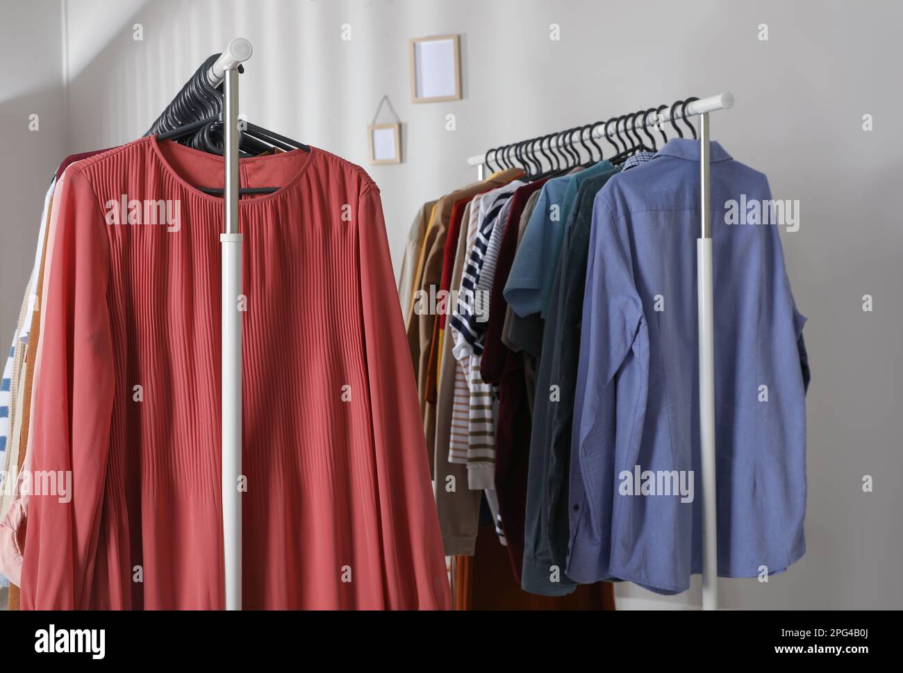 Racks with stylish clothes indoors. Fast fashion Stock Photo - Alamy