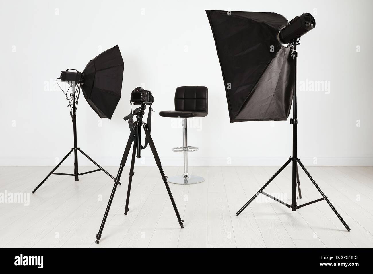 Empty chair in front of camera and professional lighting equipment ...