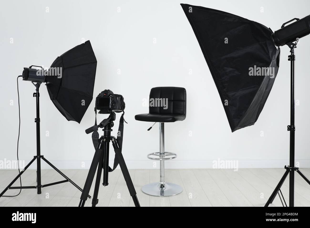 Empty chair in front of camera and professional lighting equipment ...