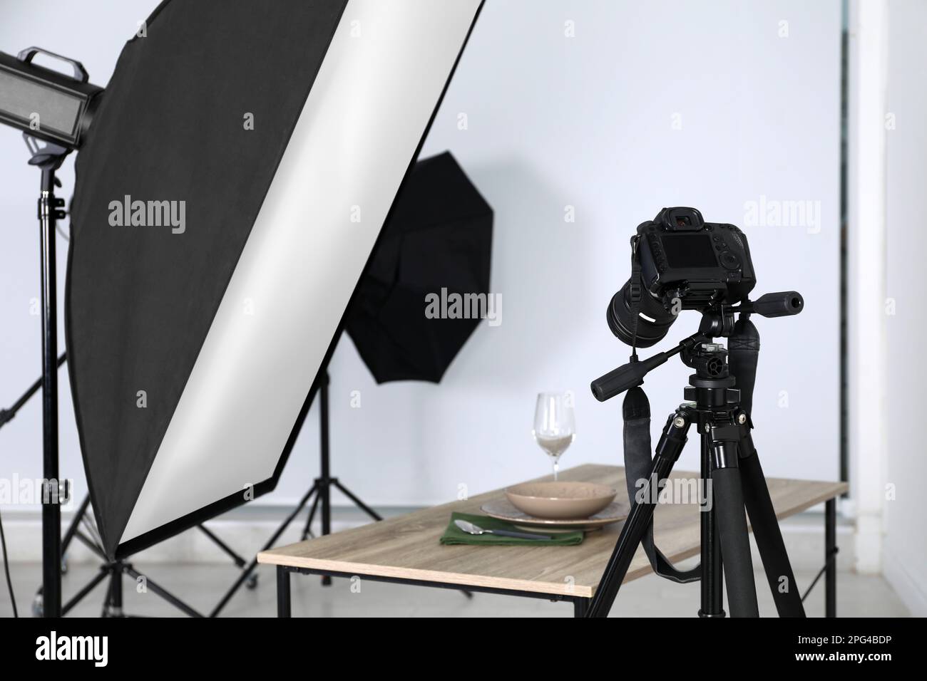Table with stylish dinnerware in front of camera and professional ...