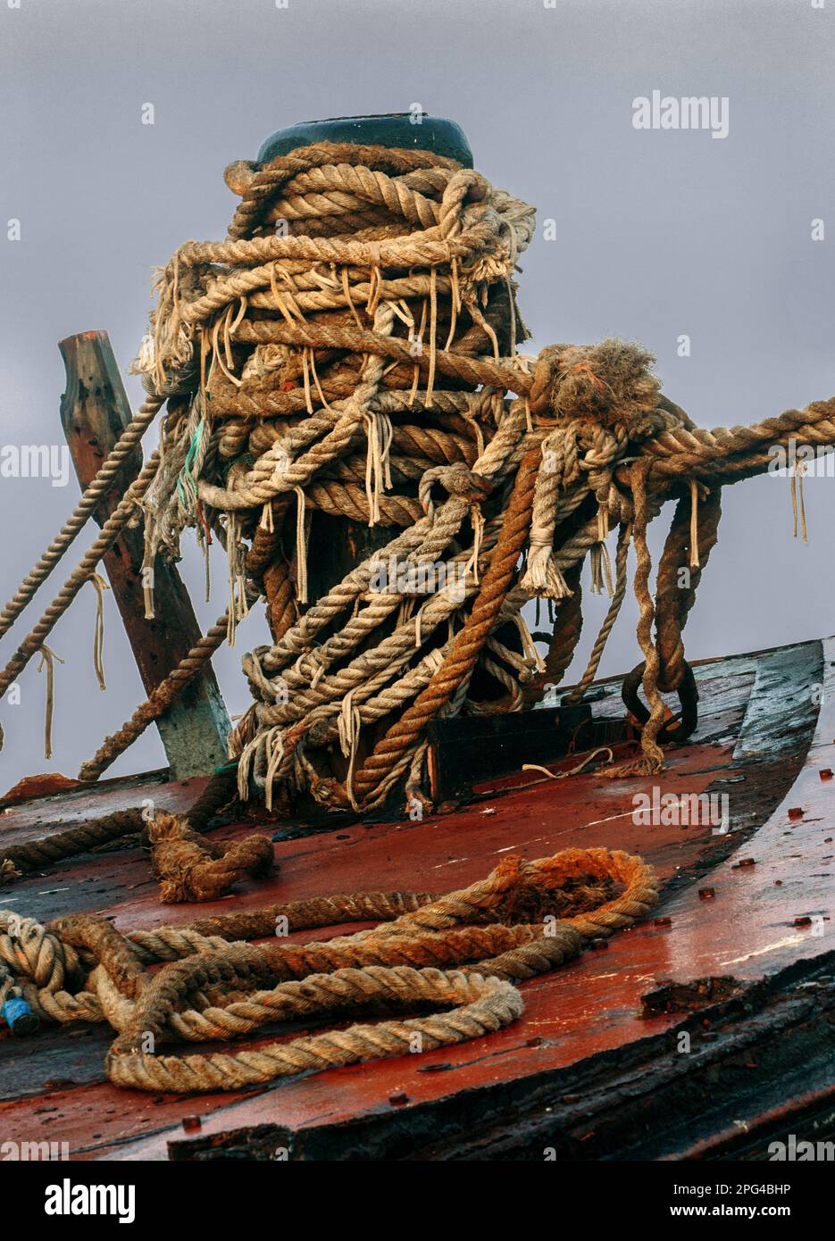 Ropes on a boat catch the first light in the harbour of Velddrif on the ...