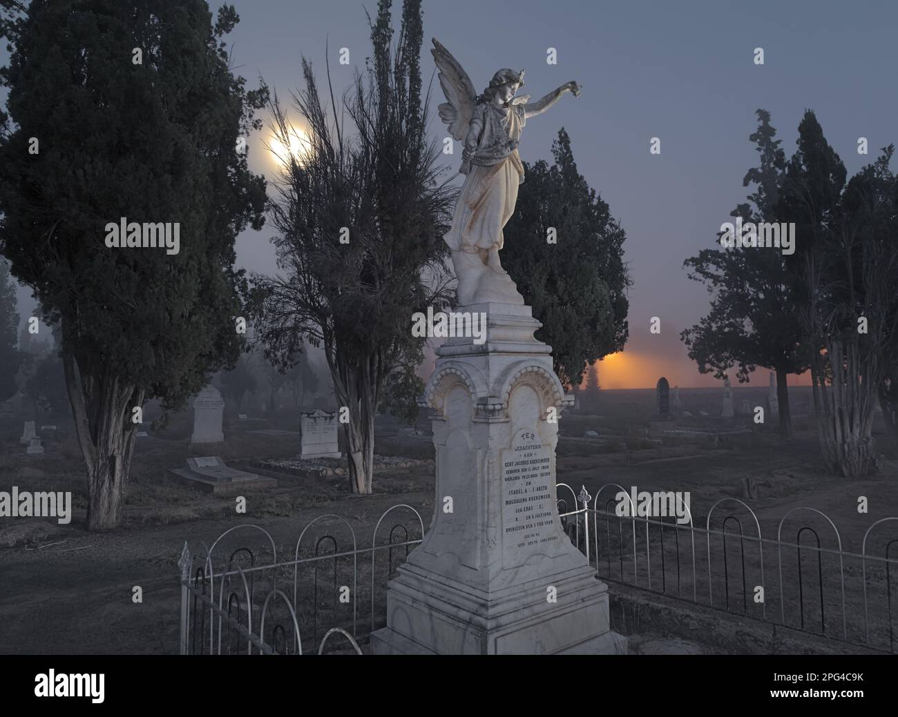 A full moon sets as morning mists envelope the cemetery in Aberdene. A ...