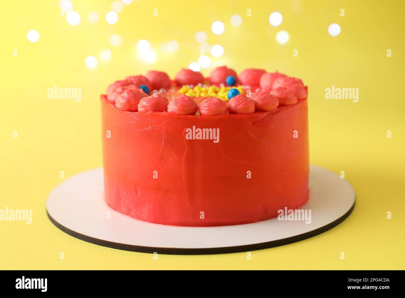 Cute bento cake with tasty cream on yellow background Stock Photo - Alamy