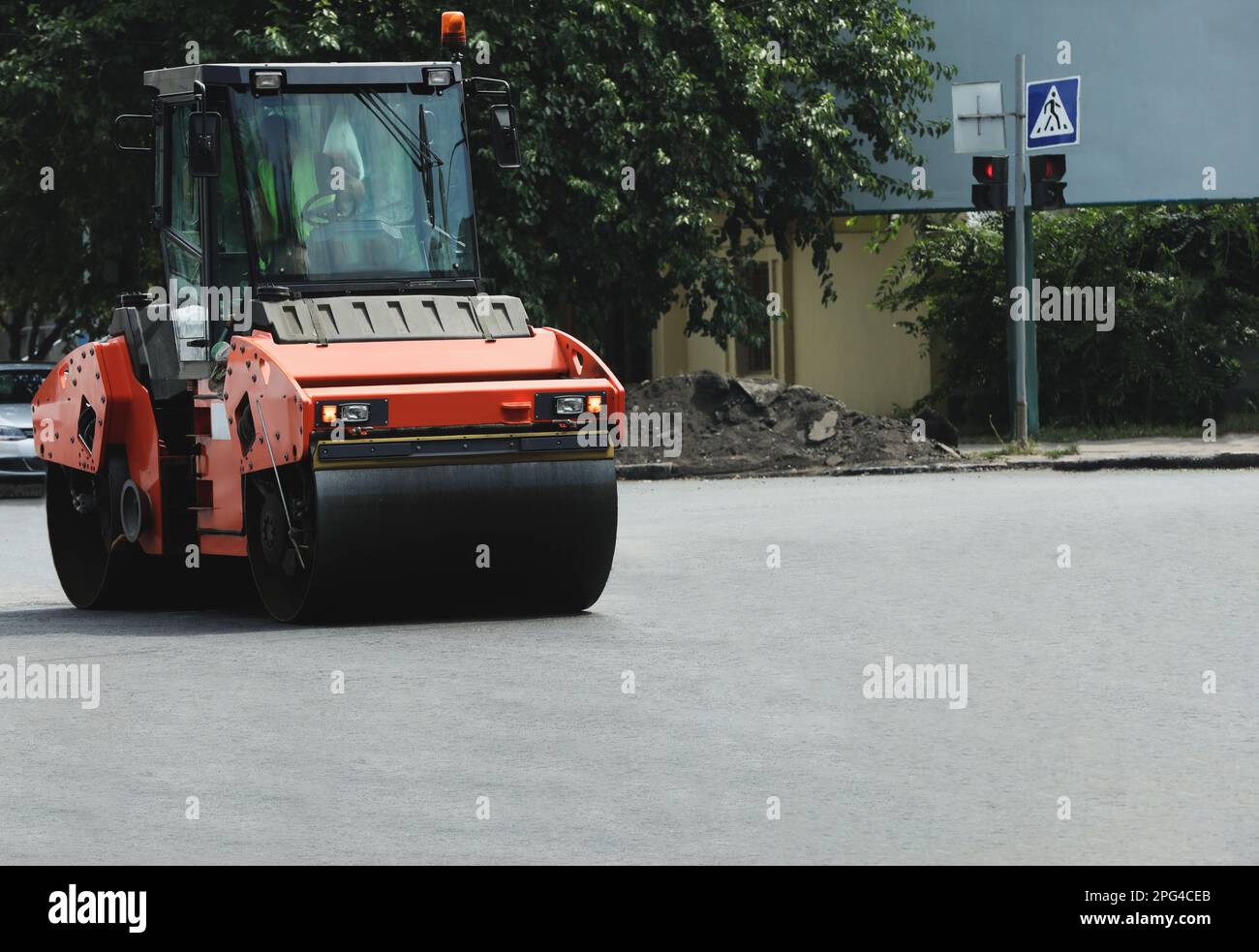 Modern roller on city street. Road repair service Stock Photo - Alamy