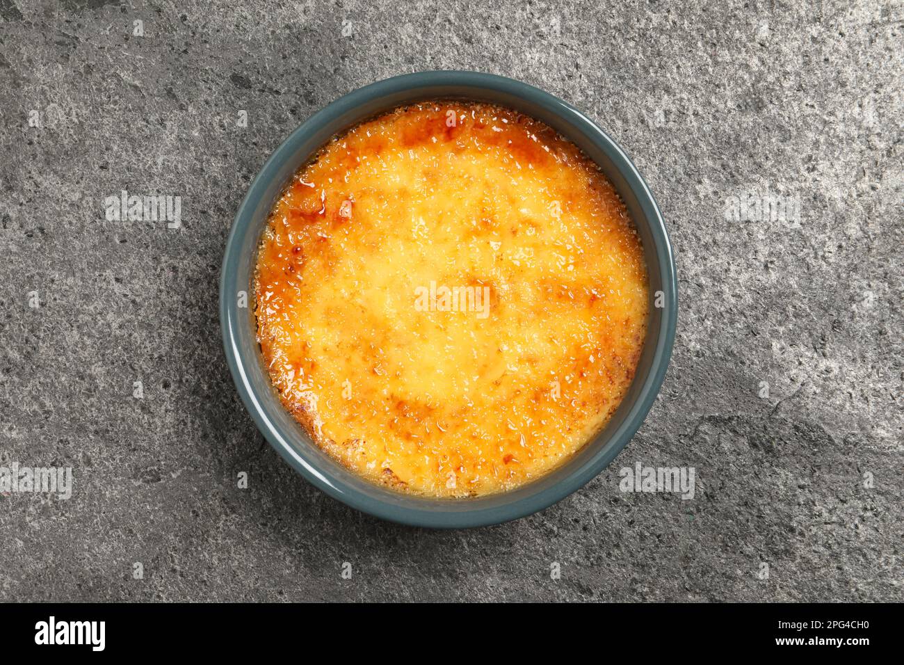 Delicious creme brulee in ceramic ramekin on grey table, top view Stock ...